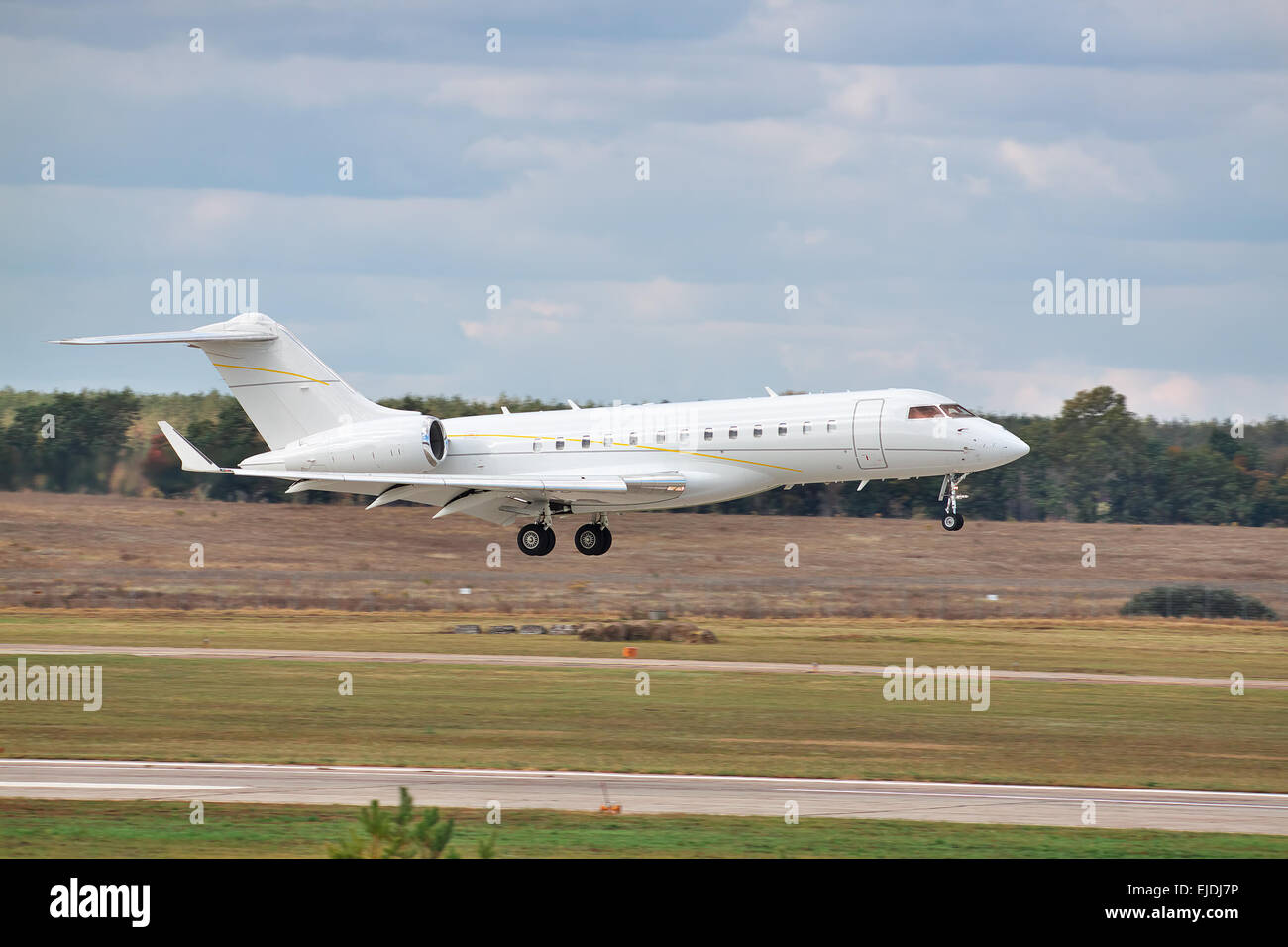 Business jet landing on the runway in the airport Stock Photo - Alamy