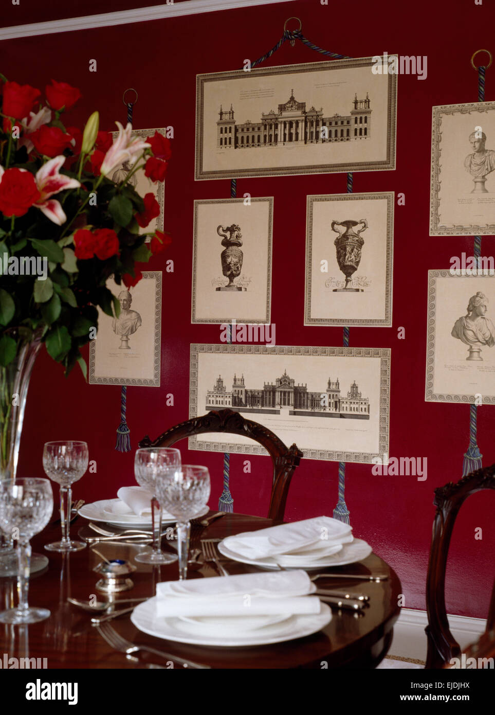 Collection of framed classical engravings on the wall in red Victorian ...