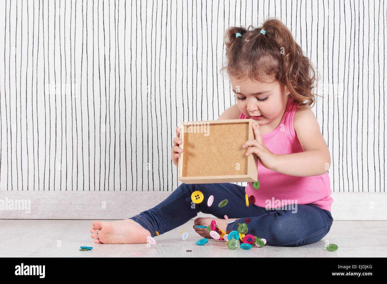 happy girl playing with some buttons Stock Photo - Alamy