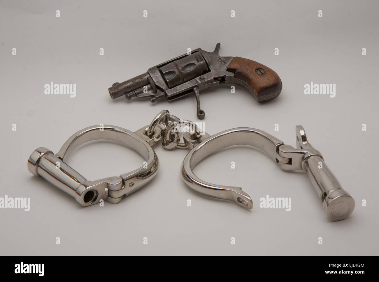 old handcuffs with locking screw English style and revolver derringer ...