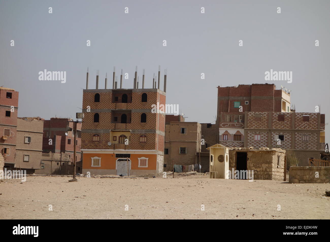 New brick buildings edge of Qena Egypt. Patterned polychrome many ...