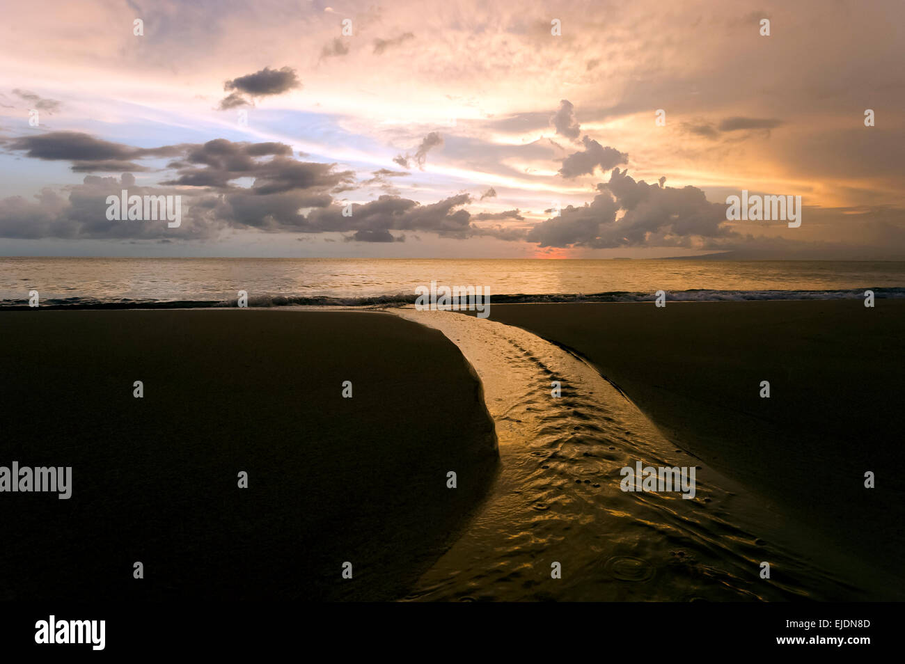 A small stream flows to the ocean at dusk Stock Photo - Alamy