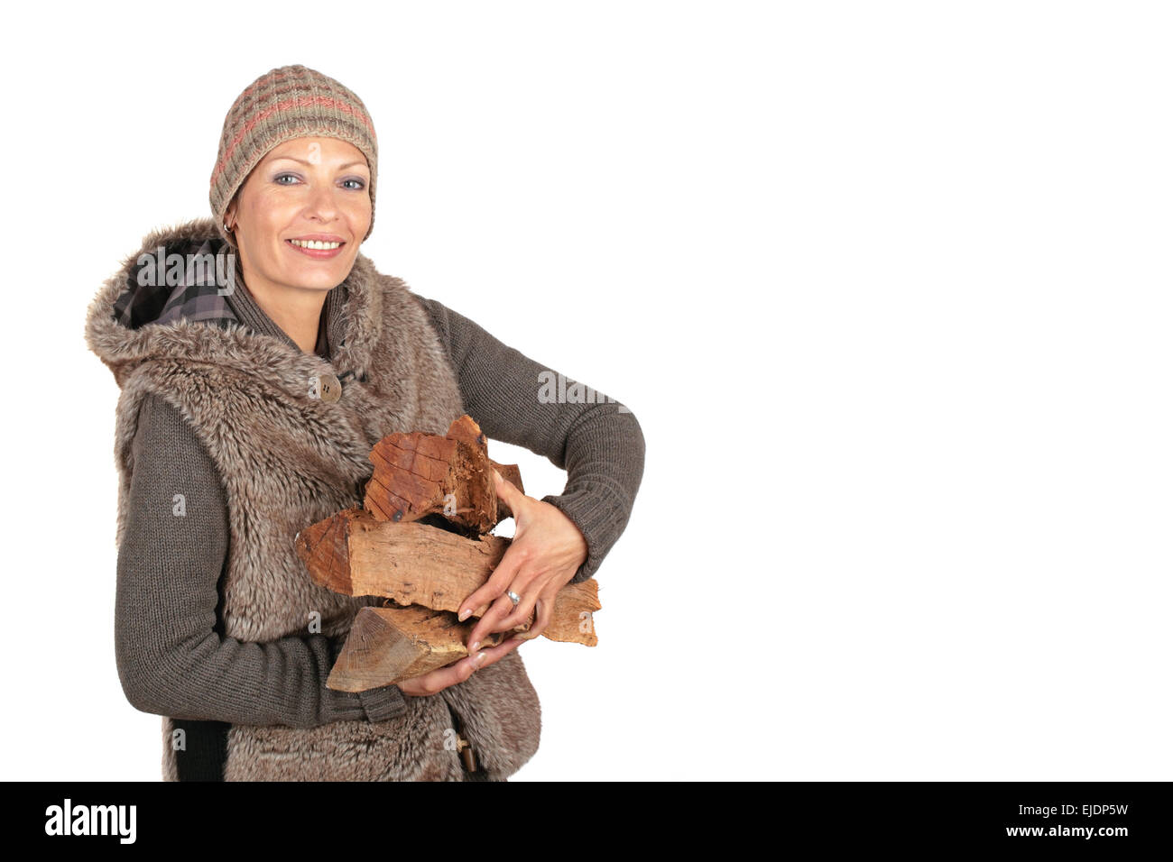 Beautiful young woman carrying firewood Stock Photo - Alamy