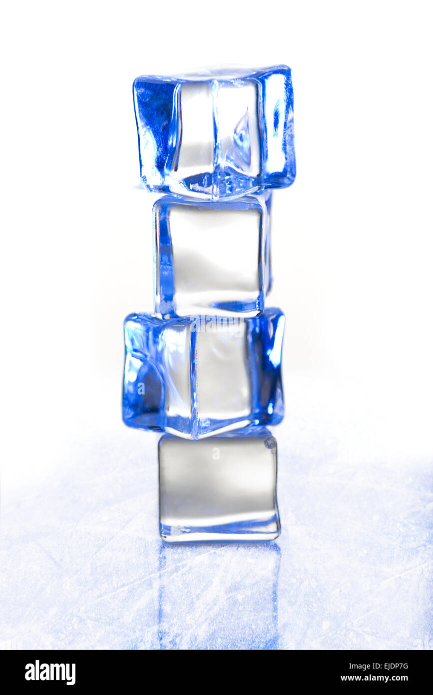 Clear blue ice cubes on the ice surface, for cold, winter related ...