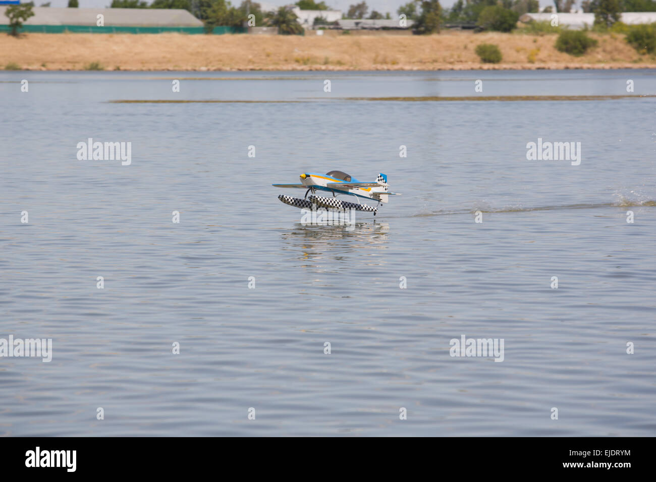Radio controlled Hydroplane flying over the Guadiana river surface ...