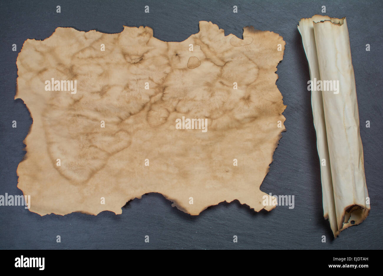 old piece of paper and paper roll on black background Stock Photo - Alamy