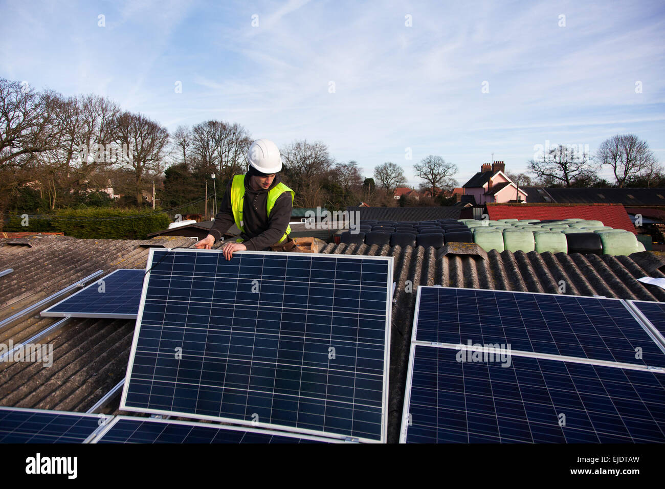 Jake Beautyman installs solar panels on a barn roof on Grange farm ...