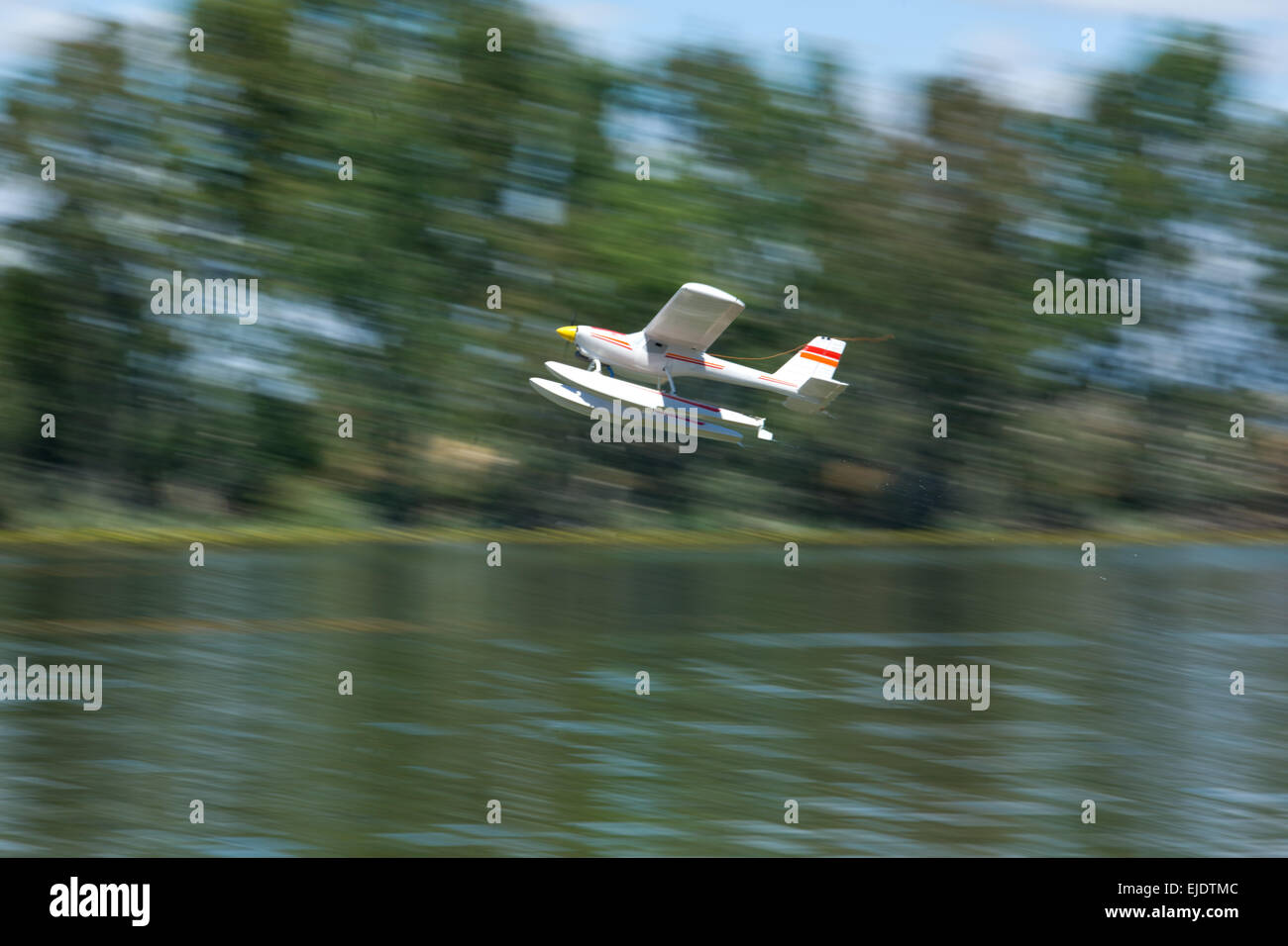 Radio controlled Hydroplane flying over the Guadiana river surface ...