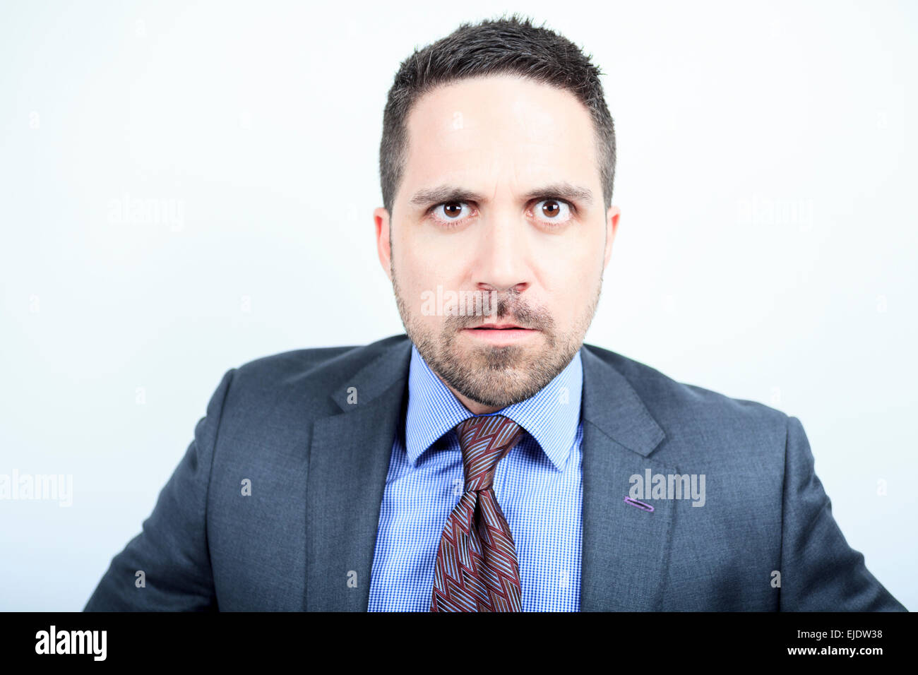 A beautiful business man standing against grey background Stock Photo ...