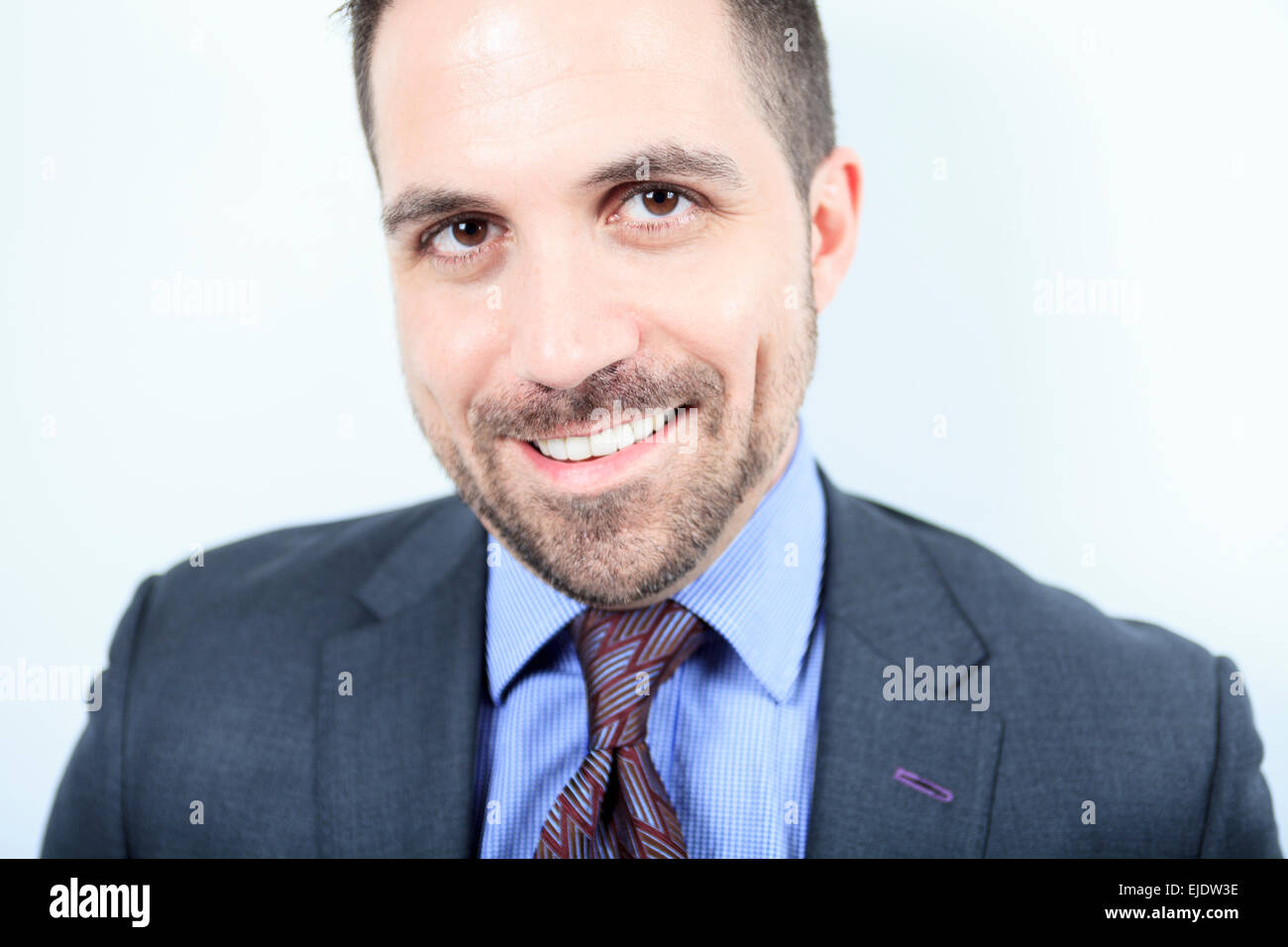 A beautiful business man standing against grey background Stock Photo ...