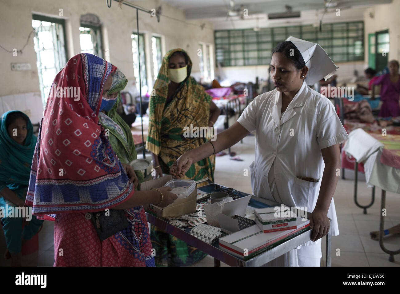 Dhaka, Bangladesh. 24th March, 2015. Tuberculosis patients receive their daily medicines at ...