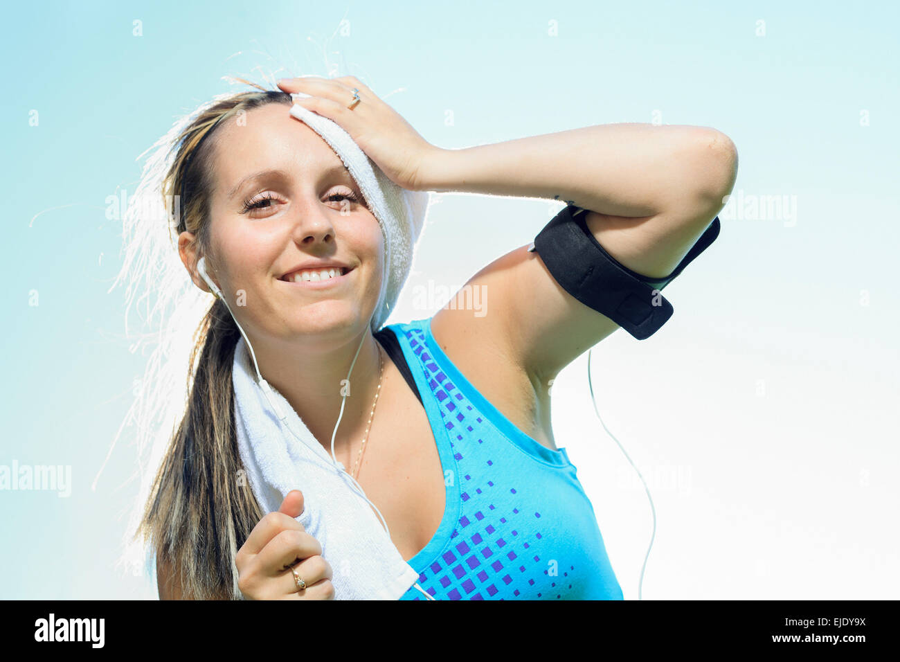 A woman cleaning her sweat with a towel Stock Photo - Alamy