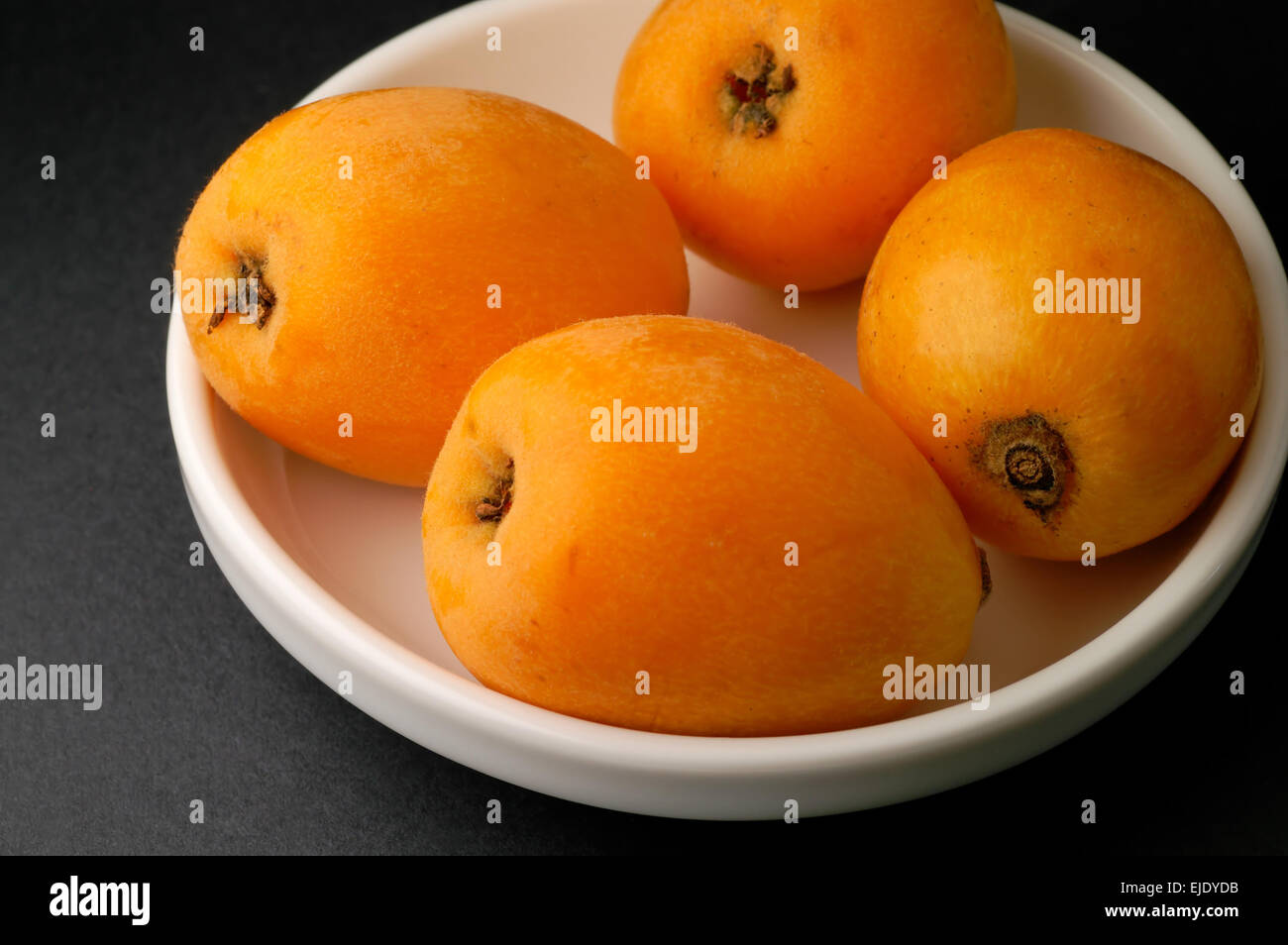 Eating loquat fruit hi-res stock photography and images - Alamy
