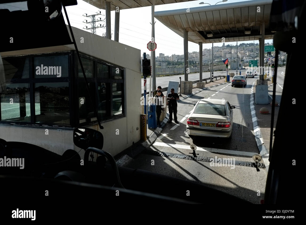 Israeli cars driving through az-Za'ayyem or al-Zaim checkpoint between ...