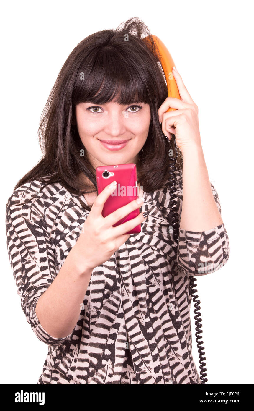 beautiful young woman using retro orange and mobile phone telephone ...
