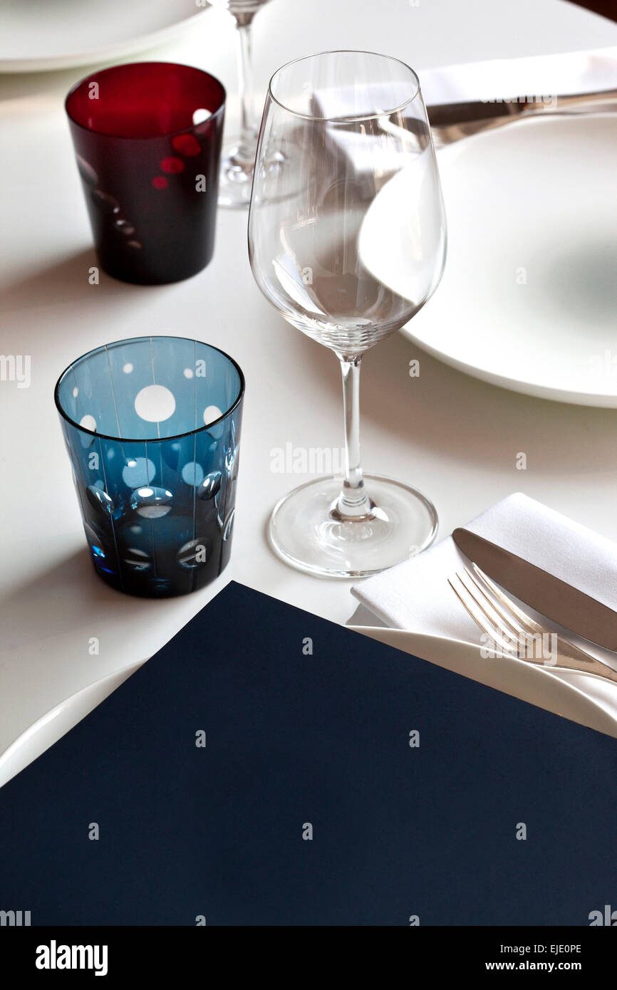 Table set and menu in a stylish restaurant Stock Photo - Alamy
