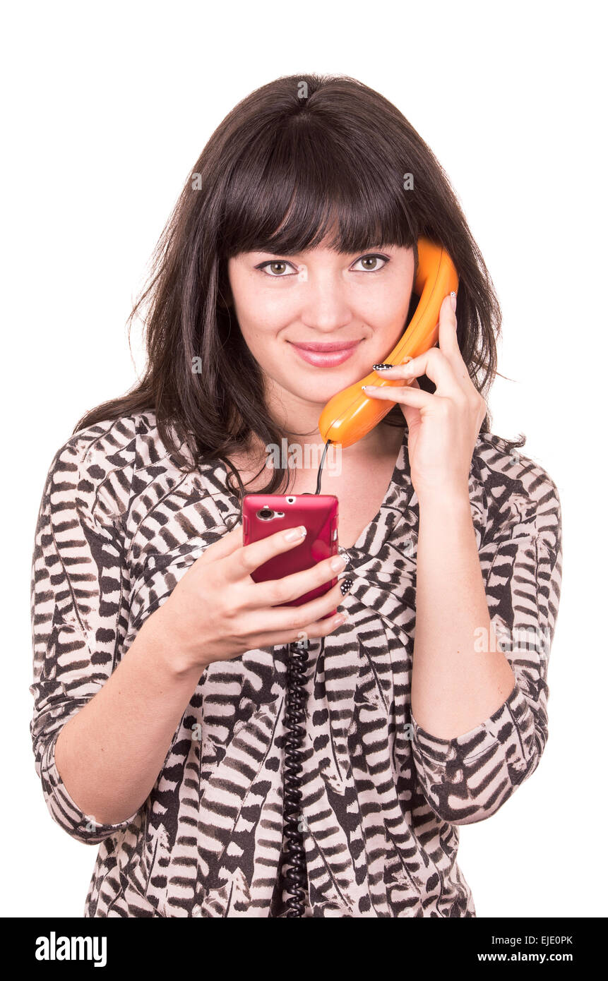 beautiful young woman using retro orange and mobile phone telephone ...