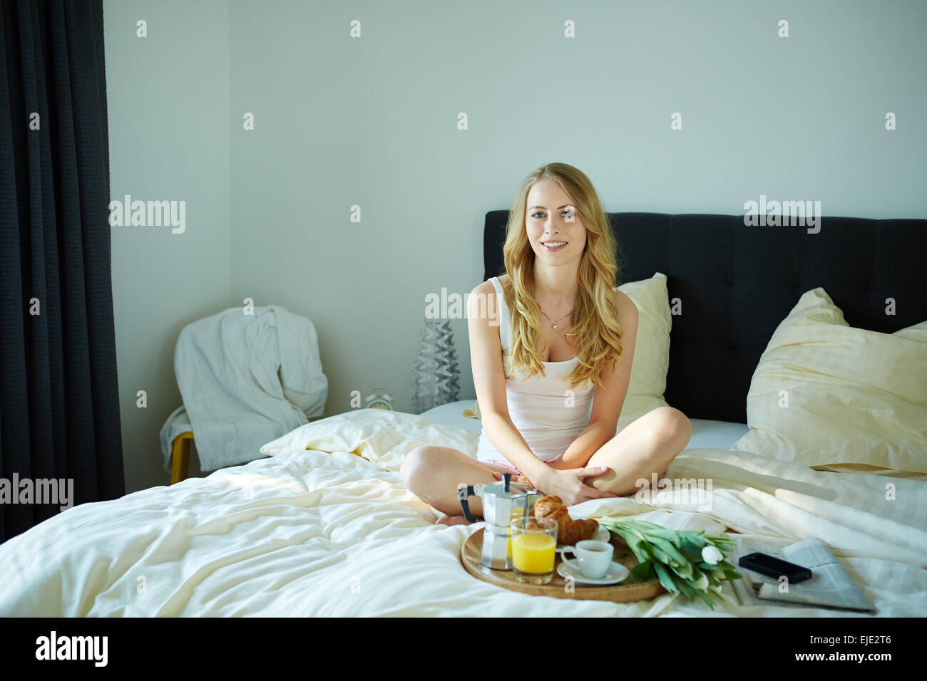 Young beautiful woman having breakfast Stock Photo - Alamy