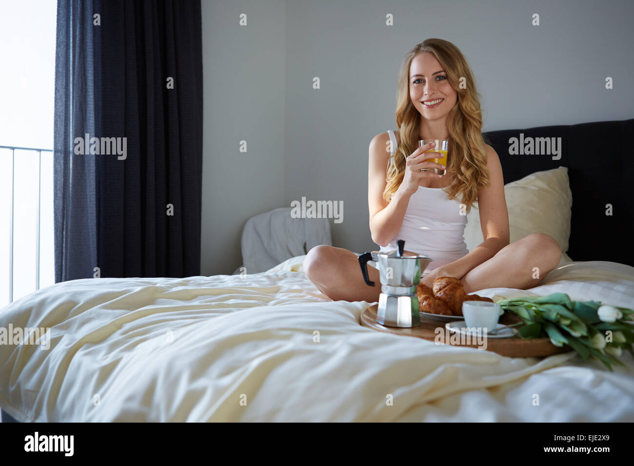 Young beautiful woman having breakfast Stock Photo - Alamy