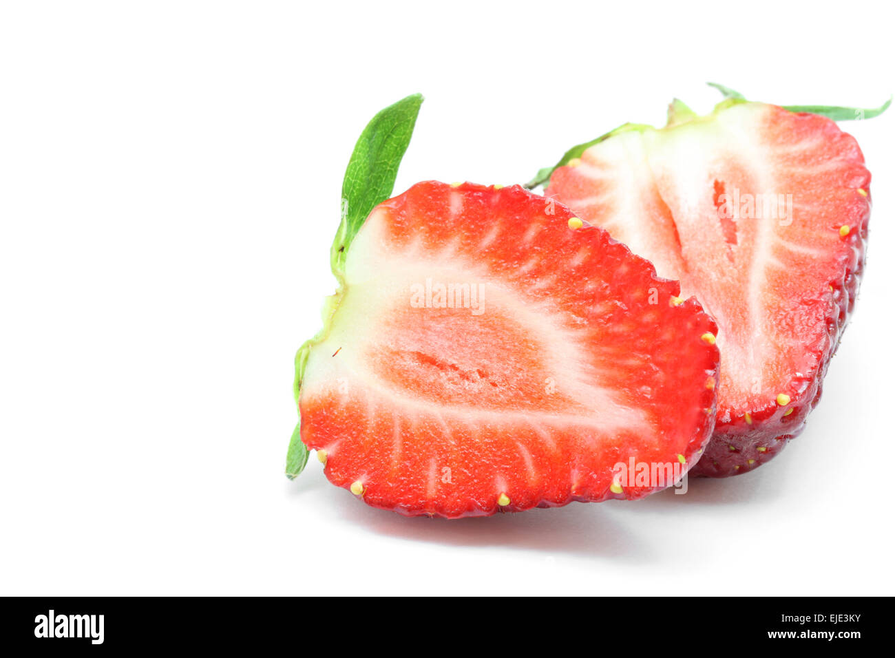 macro shot of cut half Strawberry isolated over white background Stock ...