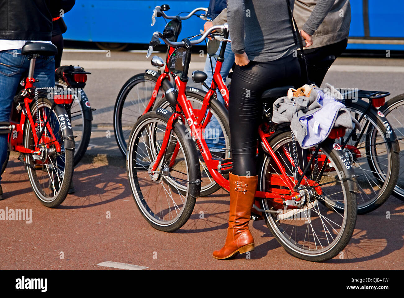 Tourists using Amsterdam red hire bikes waiting at a junction Stock ...