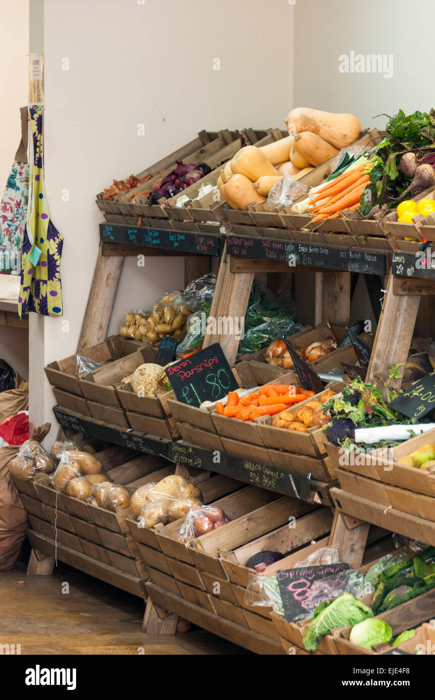 Traditional green grocers shop selling fresh vegetables in wooden boxes ...