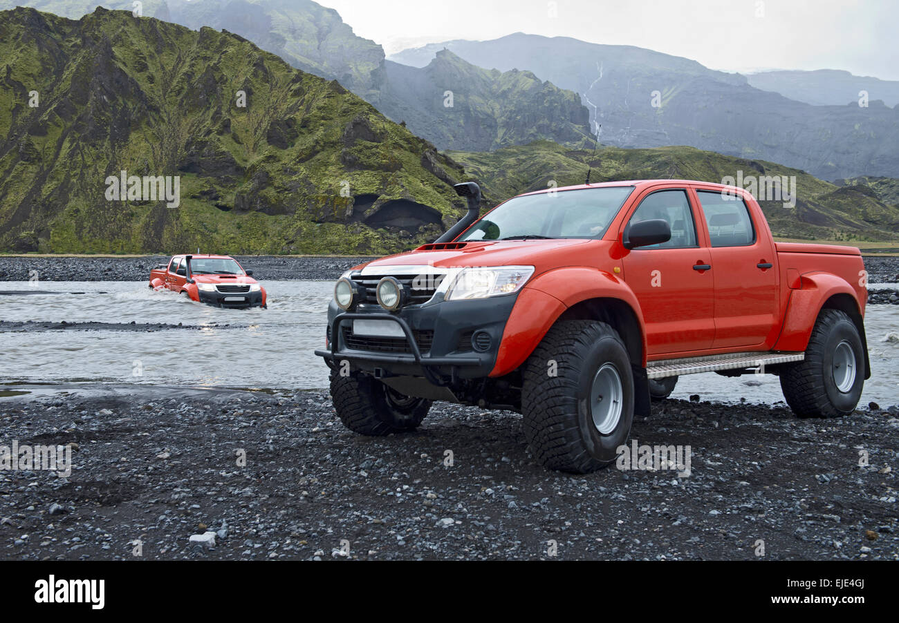 Customized pick up trucks crossing the river Krossa in Iceland Stock ...