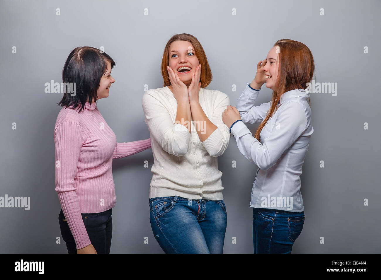 Three Female Woman Woman Friends Girl Gossip Rumors Surprise Surprise On A Gray Background Stock