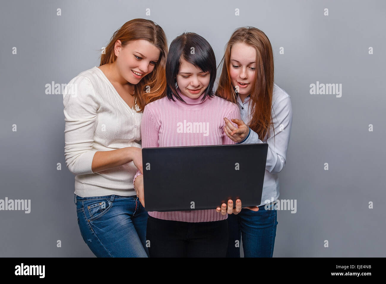 Three girls European appearance girlfriend looking at computer screen ...