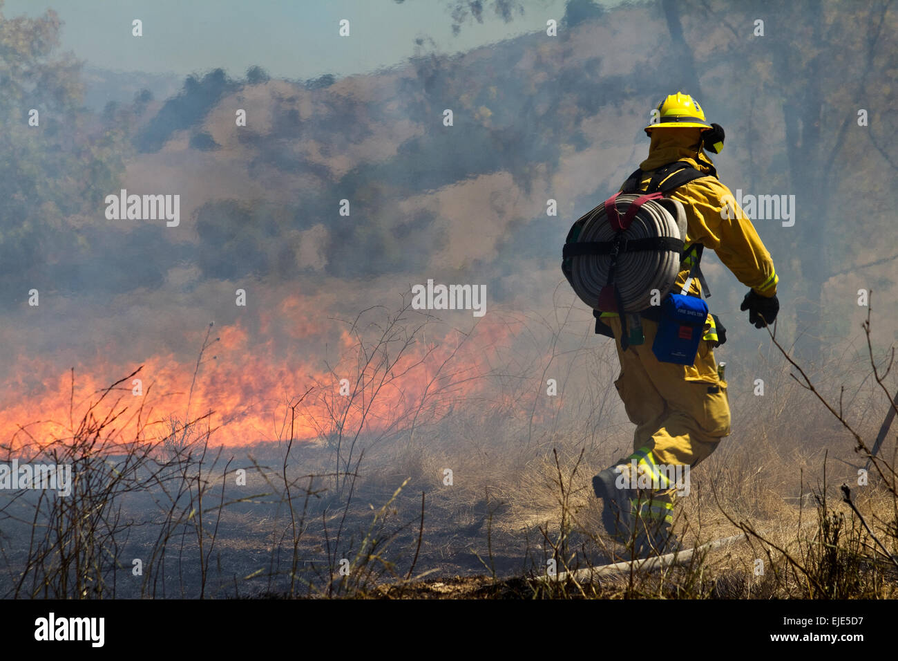 Firefighter Fighting Fire Stock Photo - Alamy