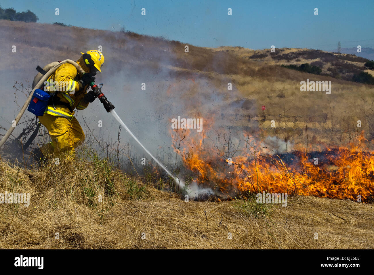 Firefighter Fighting Fire Stock Photo - Alamy