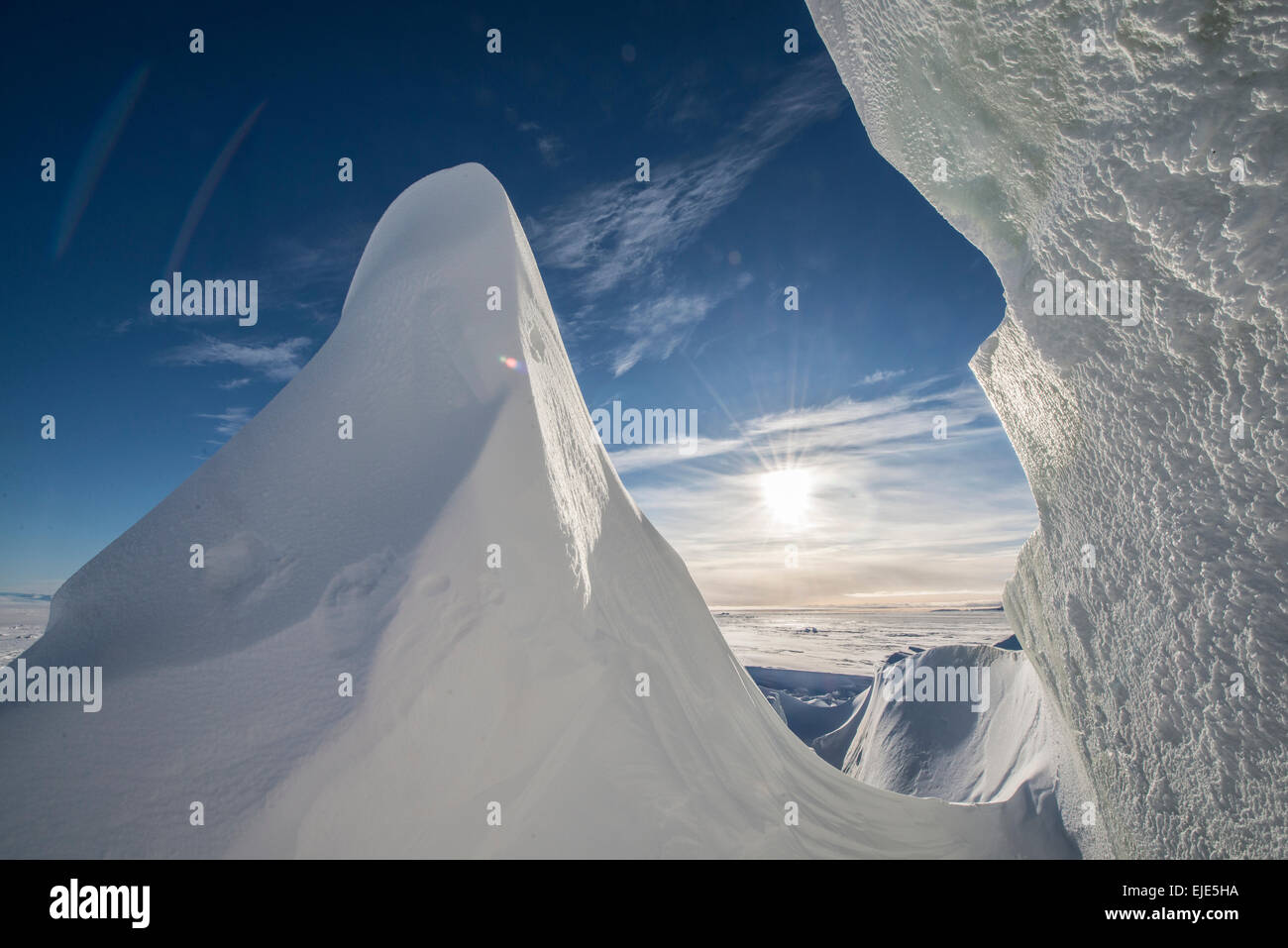 Sun shines through a crack in an iceberg in McMurdo Sound on the Ross ...