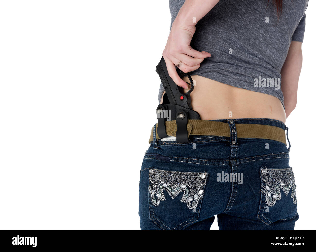 Woman Putting Hand Gun on her Hip Holster Stock Photo - Alamy