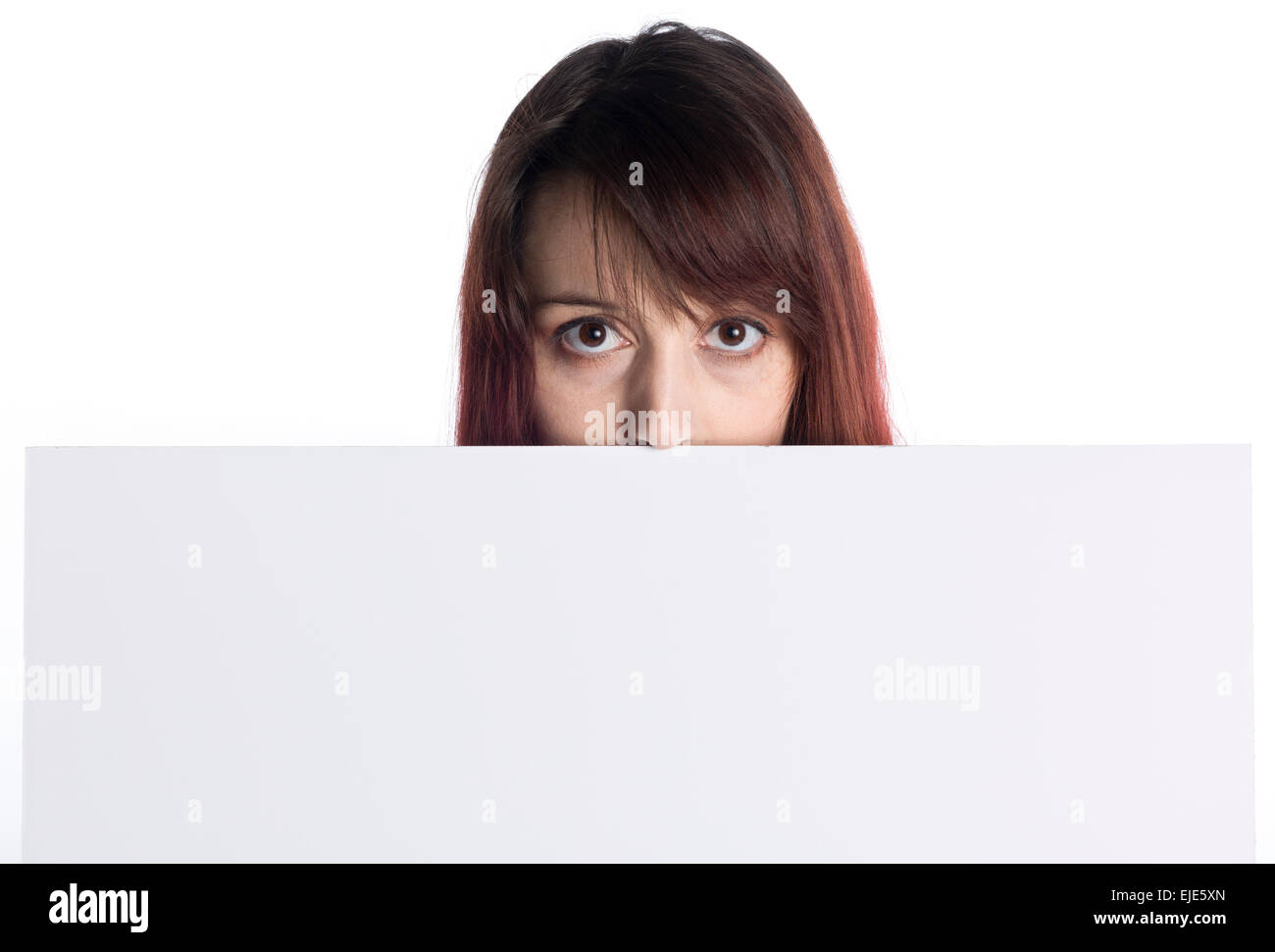 Young Woman Peeking Behind White Cardboard Stock Photo - Alamy