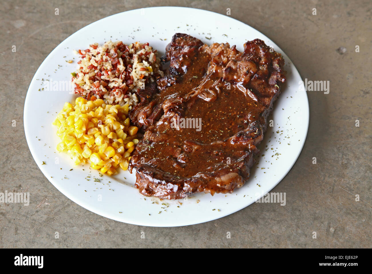 New York beef Steak dressing with corn and red rice Stock Photo - Alamy