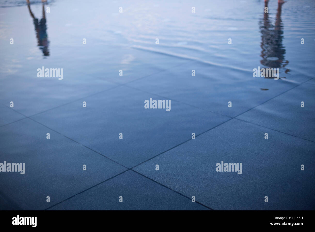 Silhouettes of people walking in a puddle Stock Photo - Alamy