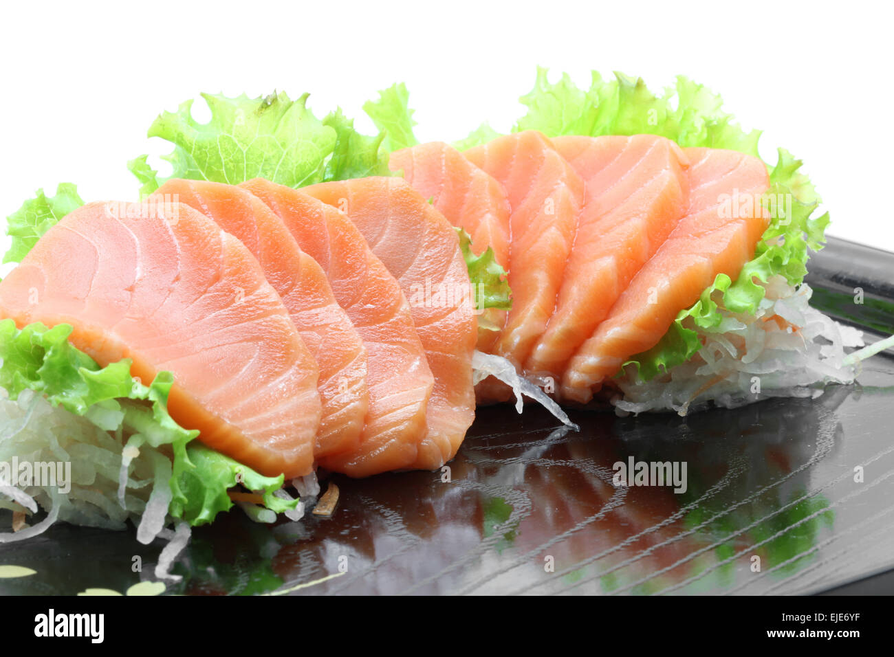 appetizer salmon sashimi on black dish with reflection Stock Photo - Alamy