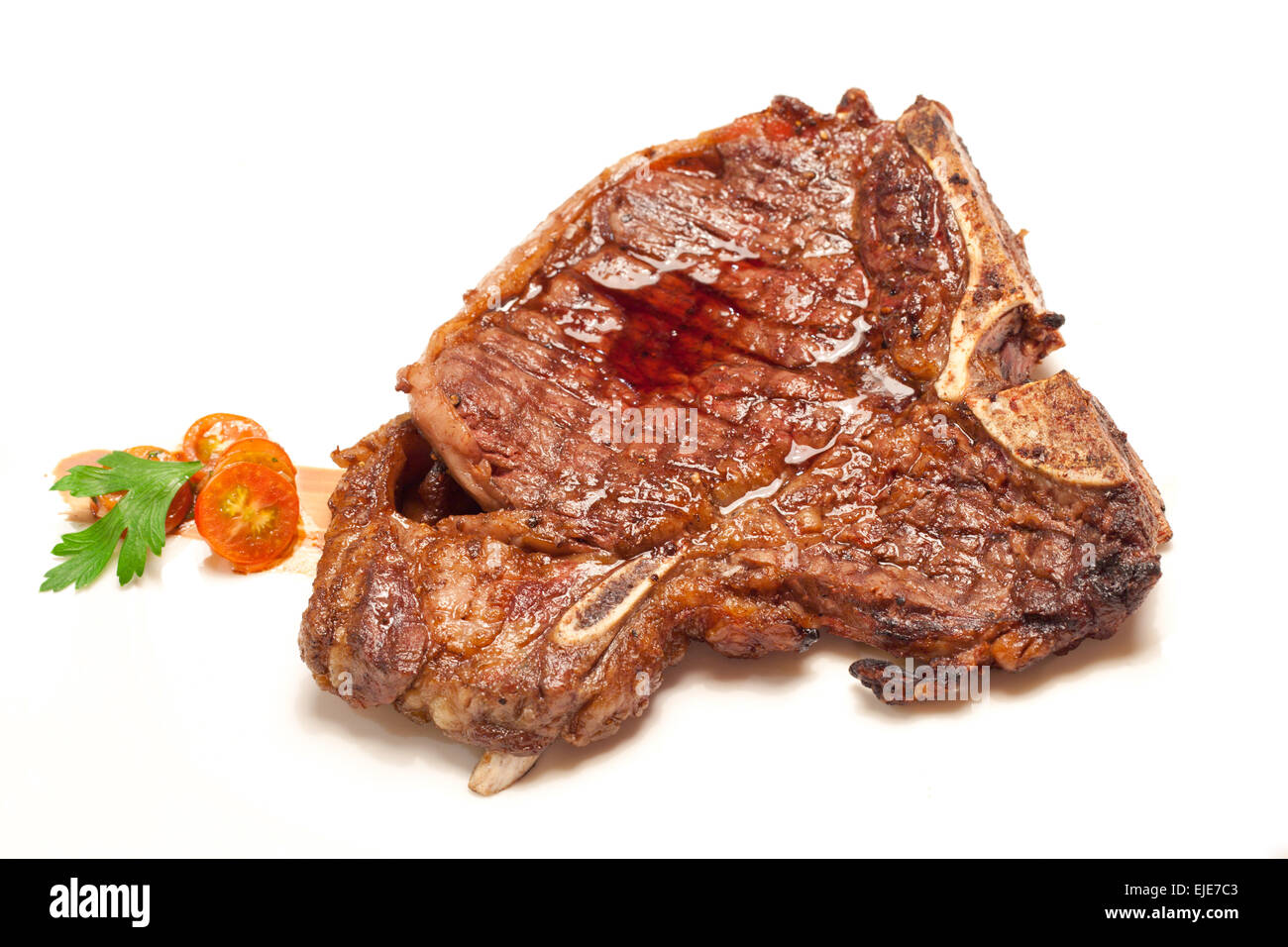 Gourmet Main Entree Course t-bone beef grilled steak on white dish ...
