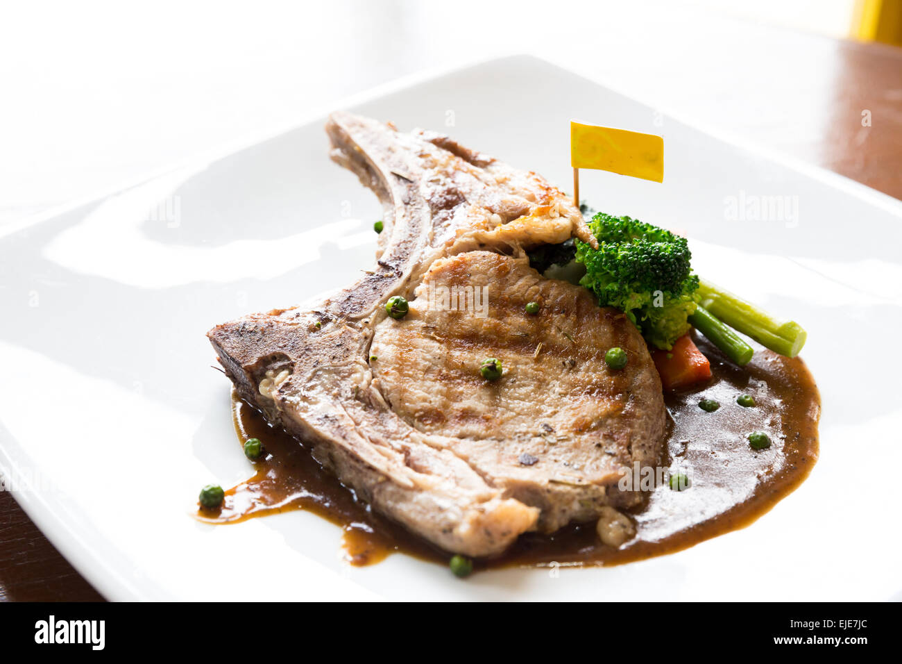 Gourmet Main Entree Course grilled pork chop Stock Photo - Alamy