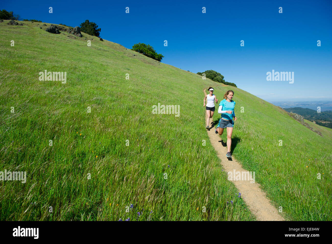 Two girls run in California Stock Photo - Alamy