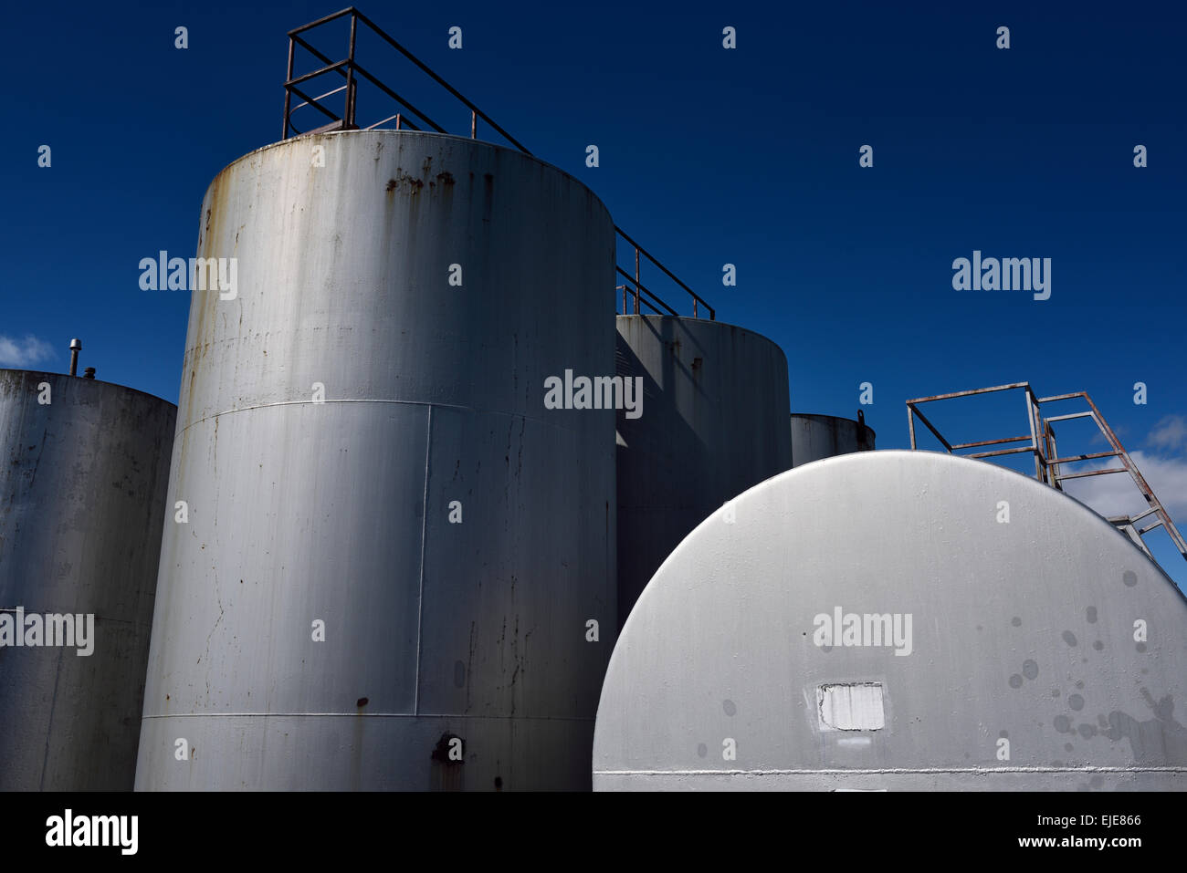 Industrial gray metal storage tanks for oil at a chemical plant with ...