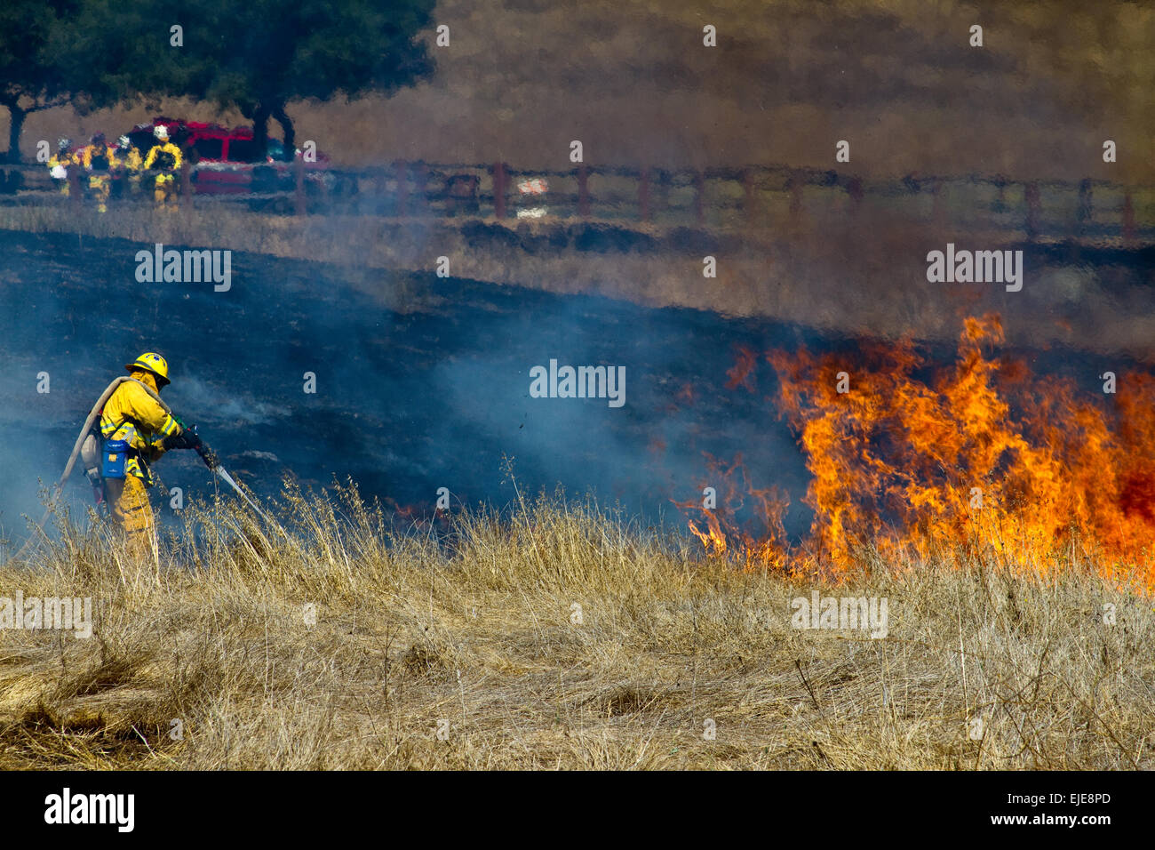 Firefighter Fighting Fire Stock Photo - Alamy
