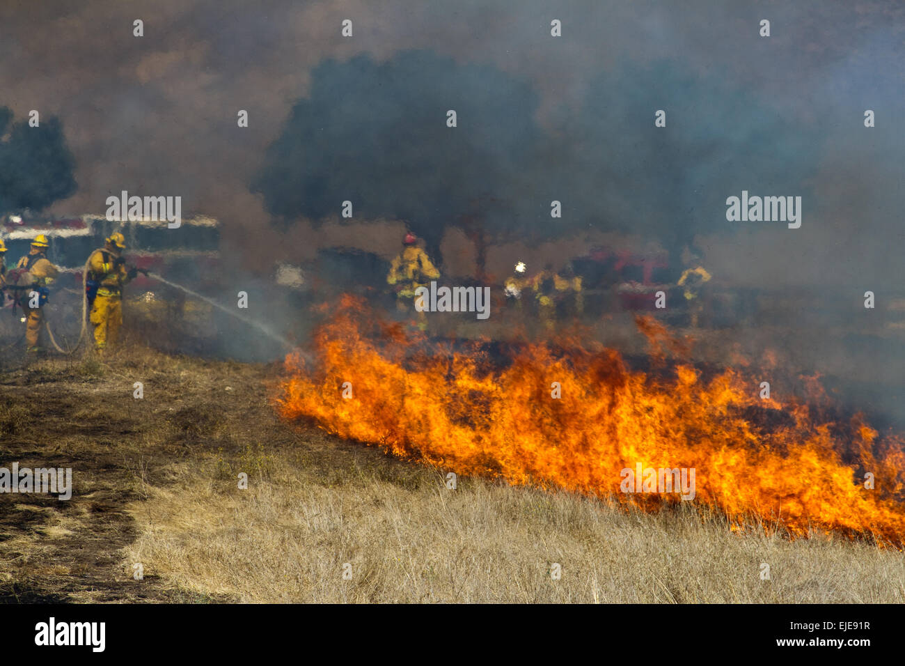 Firefighter Fighting Fire Stock Photo - Alamy
