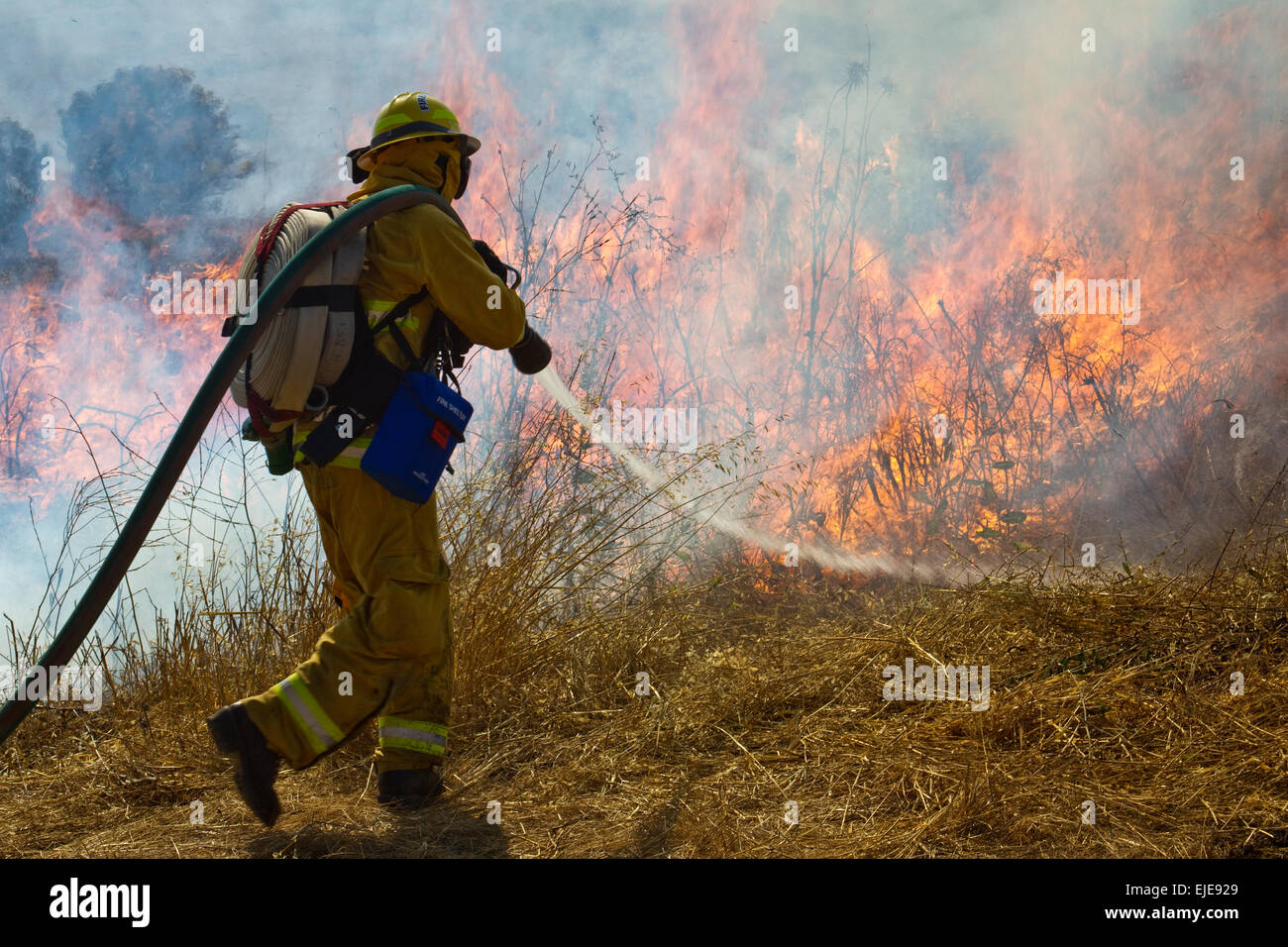 Firefighter Fighting Fire Stock Photo - Alamy