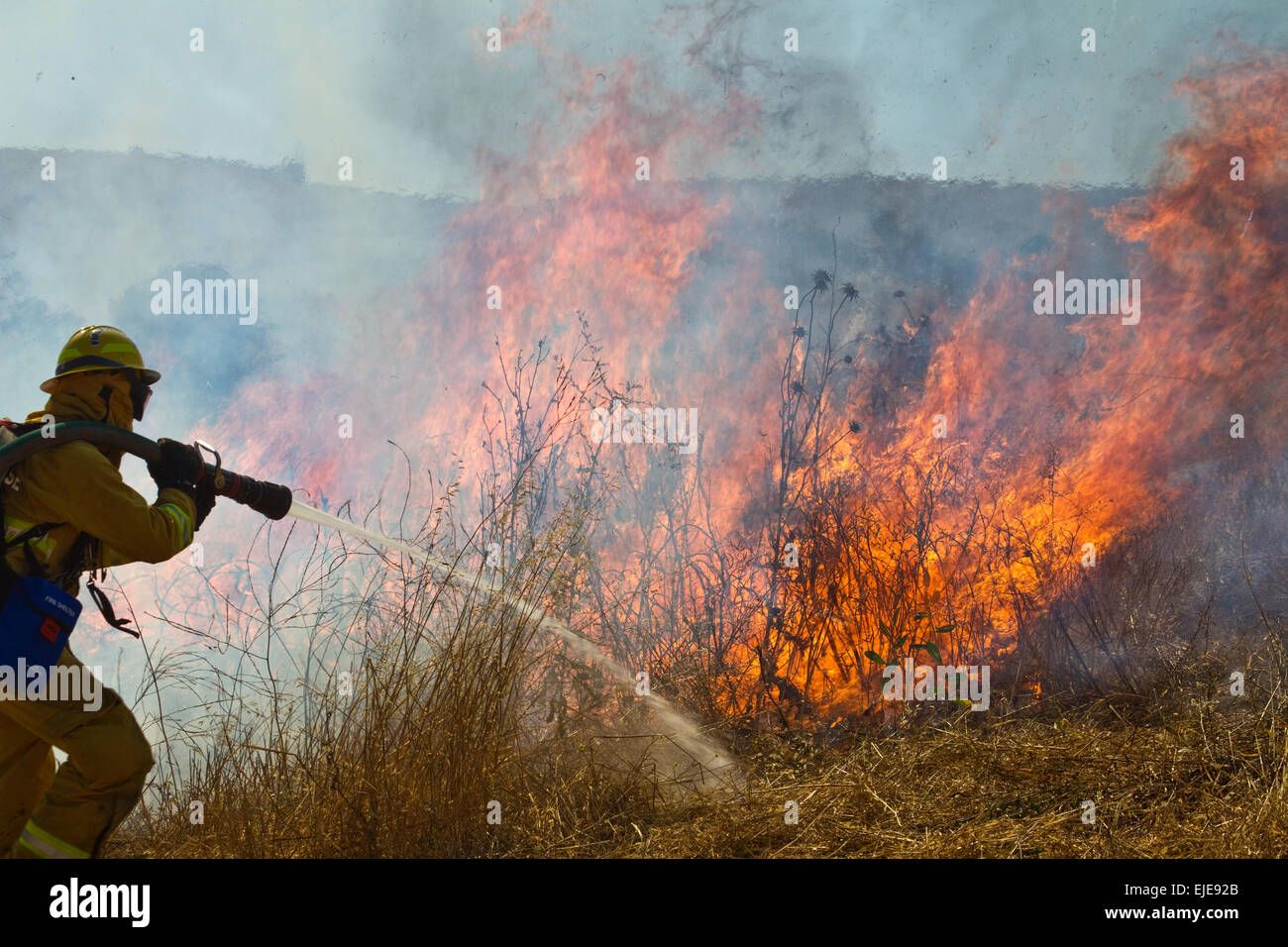 Firefighter Fighting Fire Stock Photo - Alamy