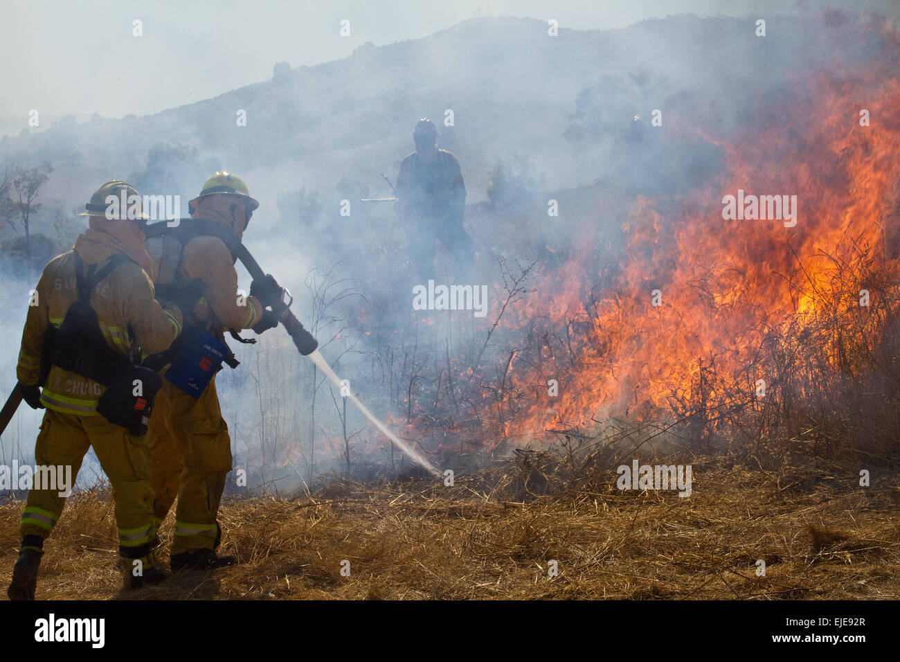 Firefighter Fighting Fire Stock Photo - Alamy