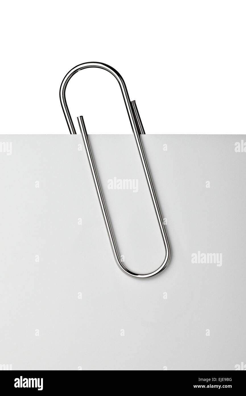 close up of a metal paper clip and paper on white background Stock ...