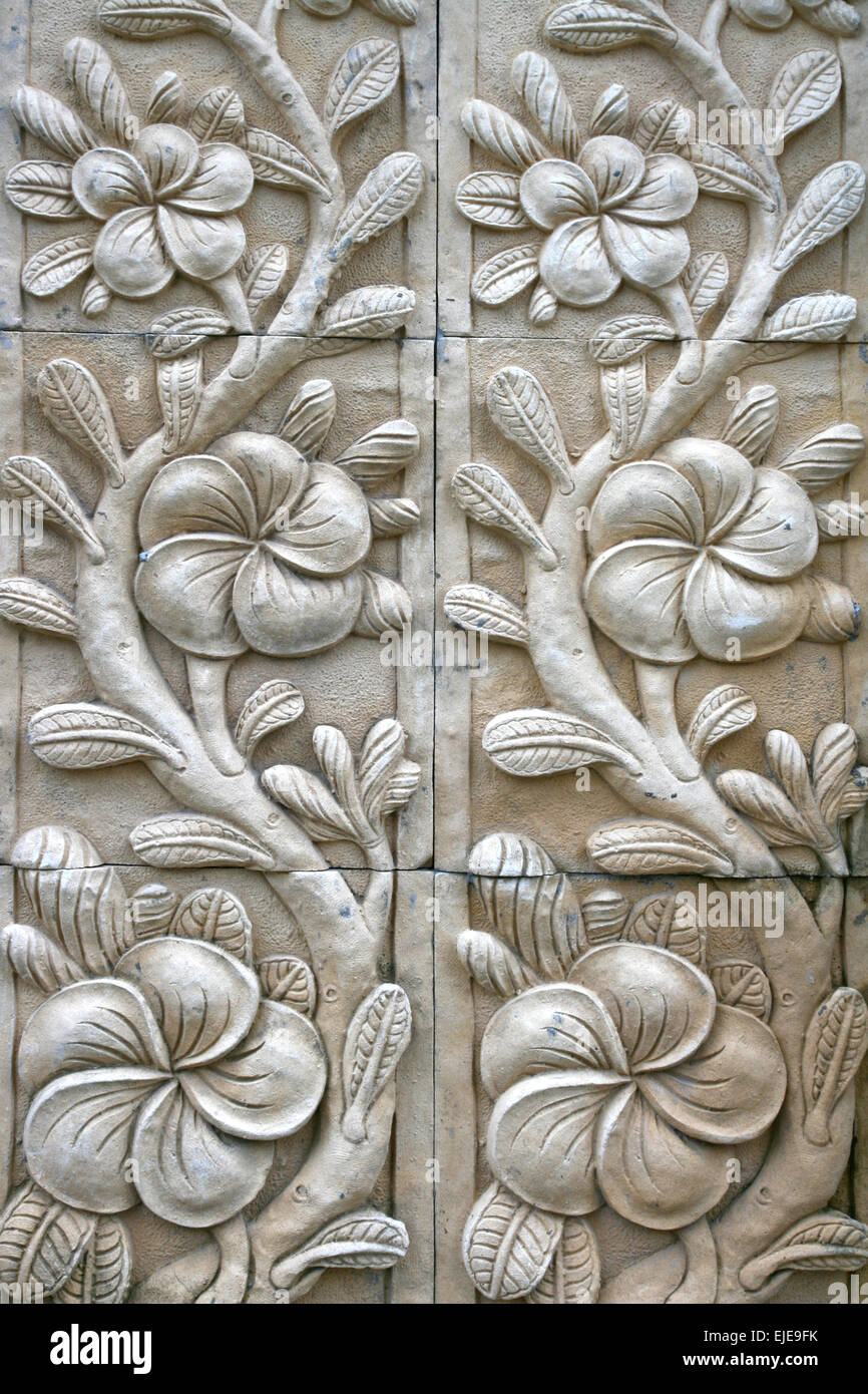 flower shape stone carving on wall in bali style Stock Photo - Alamy
