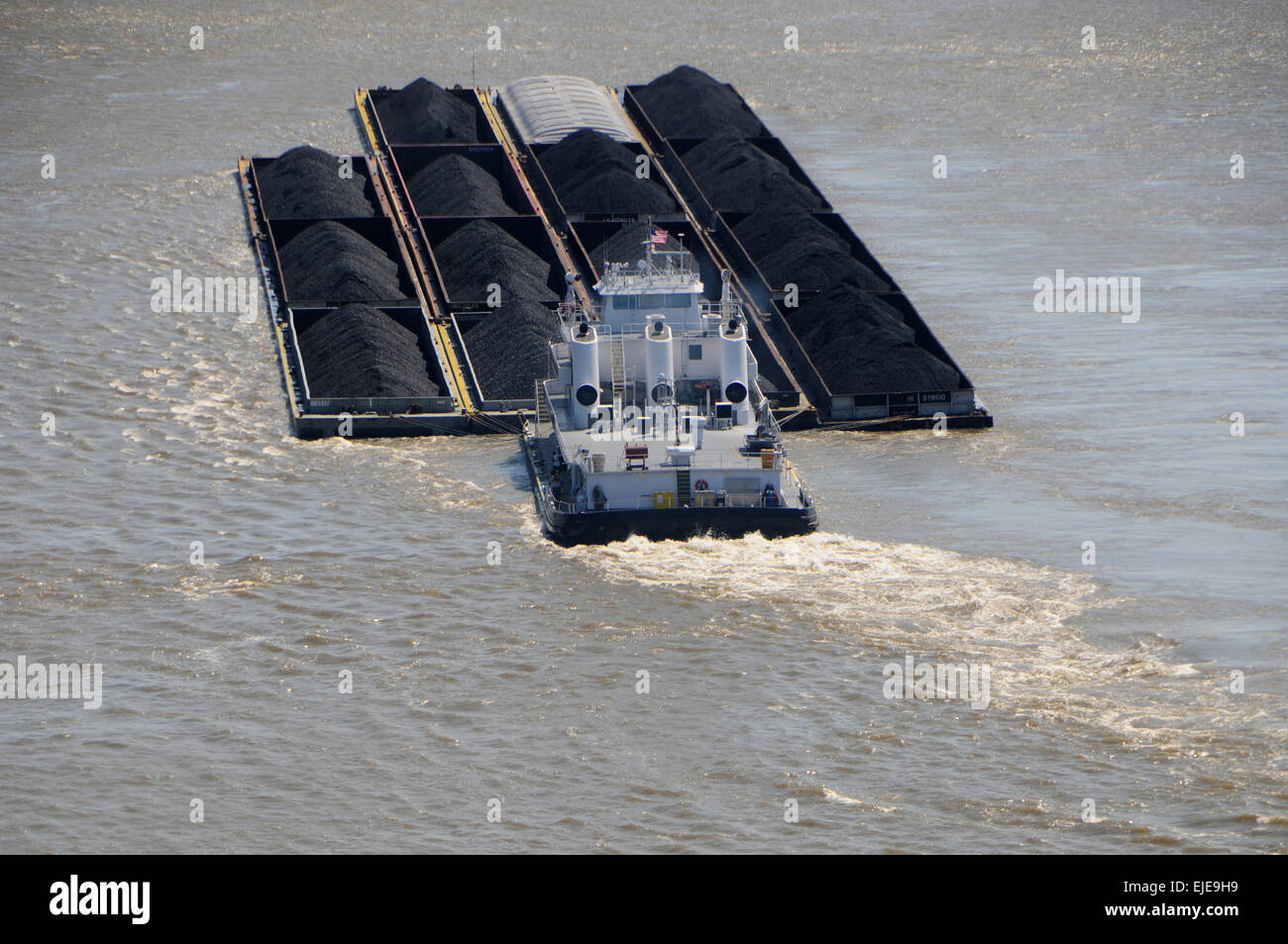 Tug boat pushing barge of coal down the Mississippi River in New ...