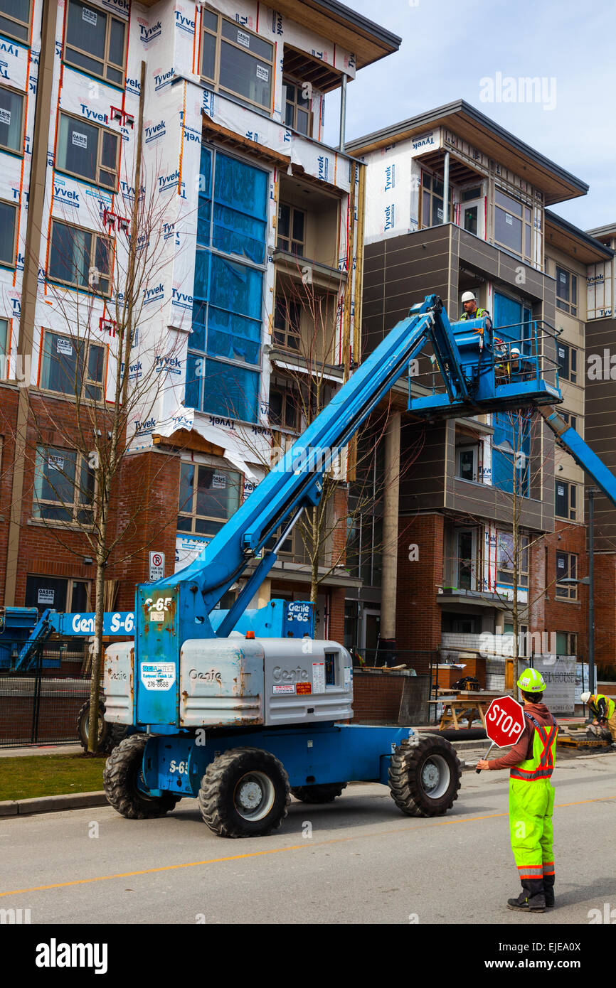 Man-lift being driven along a road to enable repositioning of the ...